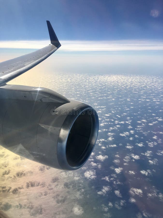Flying Over the Ocean View of Aircraft Wing and Clouds Stock Photo ...