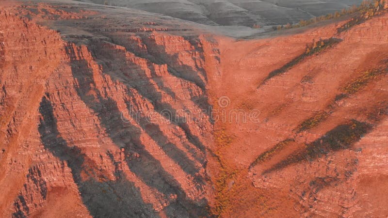 Flying Over Rugged Rocks in the Rays of the Setting Sun, a View from a ...