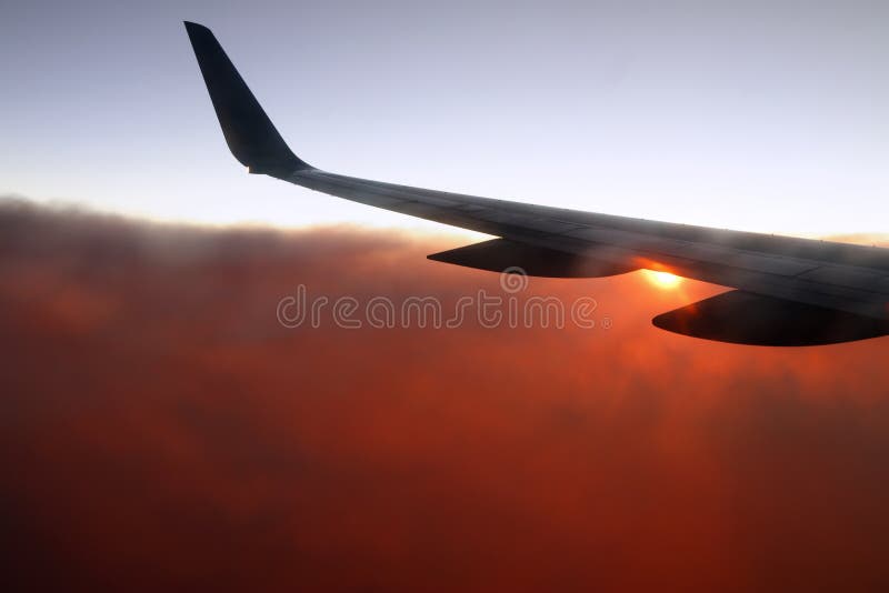 Flying Over the Sunset stock photo. Image of airplane - 21818582