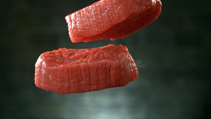Flying Pieces of Raw Beef Steaks Falling on Table Stock Photo - Image ...
