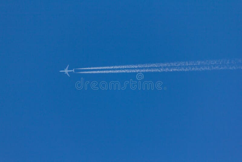 Flying Plane Leaves an Inversion Trail in the Air Stock Image - Image ...