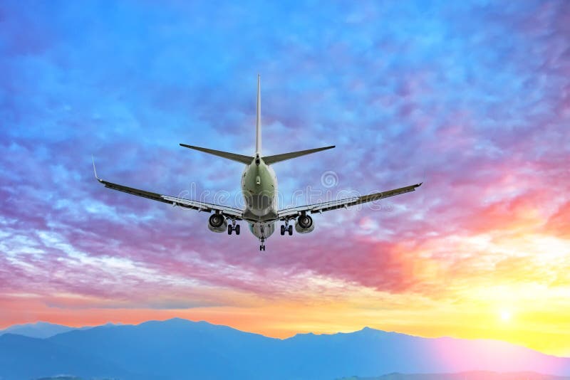 Flying Plane Over the Mountains during a Beautiful Sunset Stock Image ...