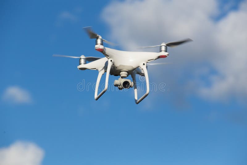 Flying Quadcopter in Blue Sky Stock Image - Image of quadcopter ...