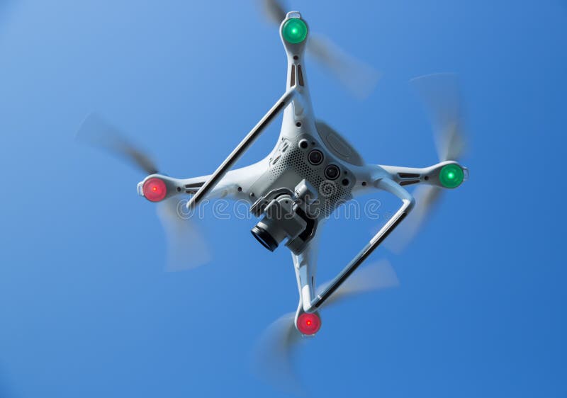 Flying Quadcopter in Blue Sky Stock Image - Image of motion, horizontal ...