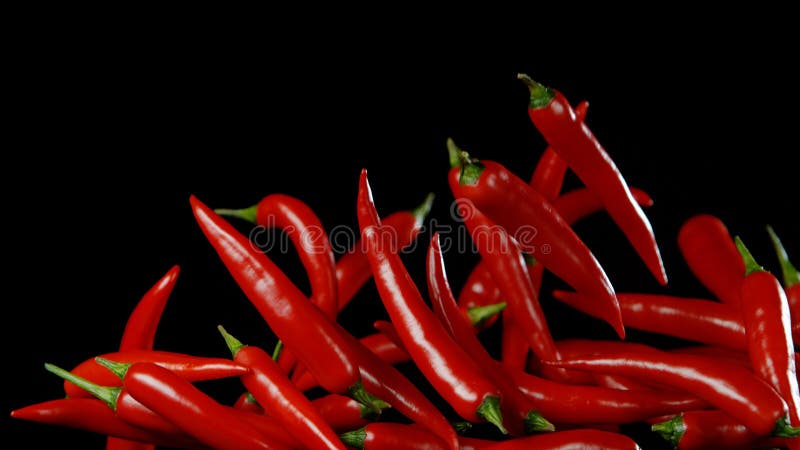 Flying hot red peppers stock image. Image of gourmet - 143503981