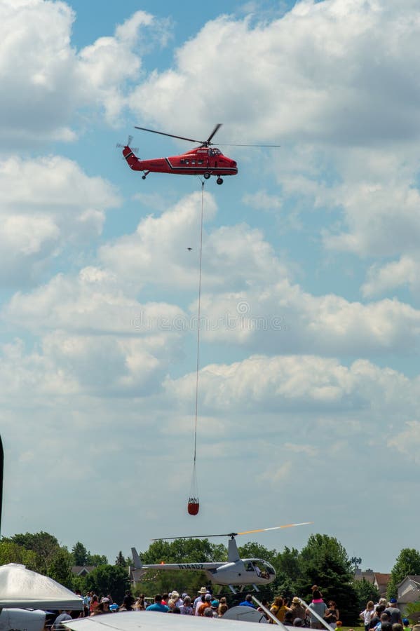 Red Helicopter Against the Blue Sky Performing at Airshow Editorial ...