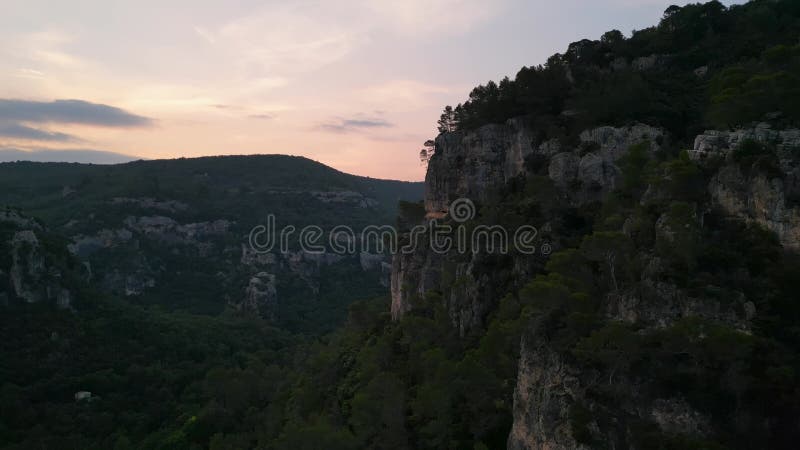 Flying by Sheer Limestone Cliffs Over Quiet Valley at Sunset Stock ...