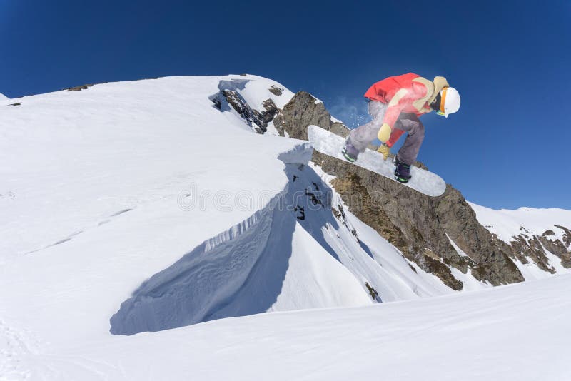 Flying Snowboarder on Mountains Stock Photo - Image of snowboarder ...