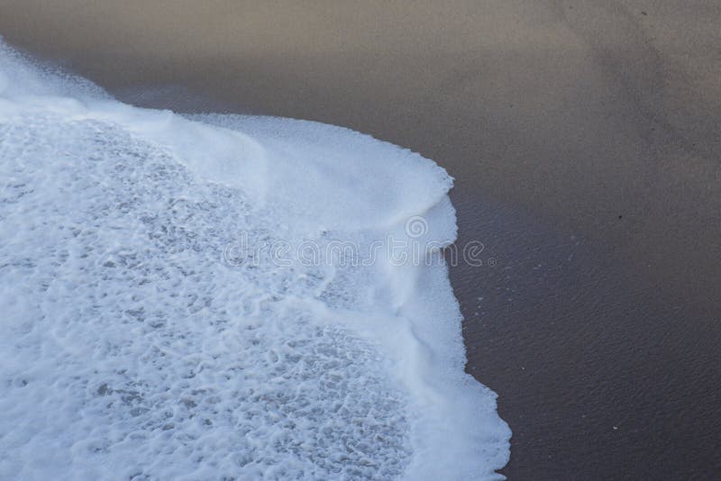 Foam of the Waves Rising on the Sand of the Beach Stock Photo - Image ...
