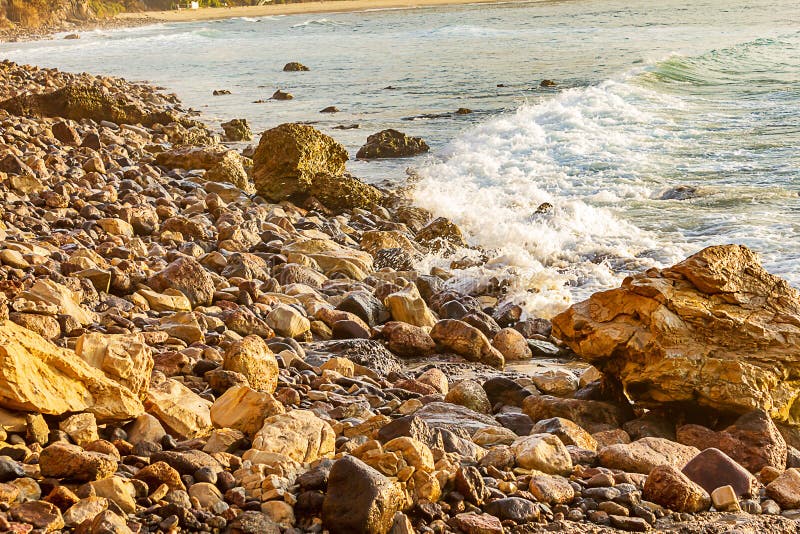 Foaming Wave Breaking at Sunrise with Rocky Shoreline Stock Photo ...