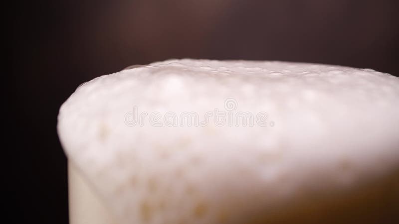 Closeup Beer Stream Pouring On Bubbling Drink Surface At White