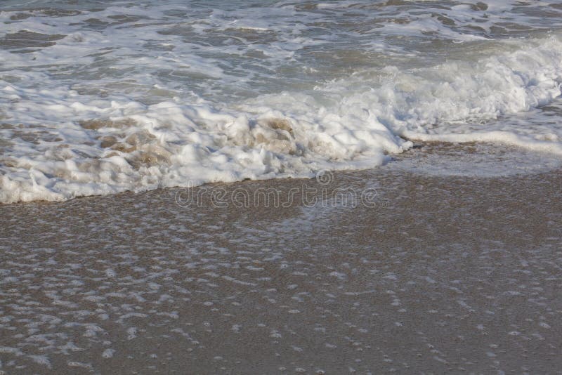 A Foamy Ocean Wave Receding on the Shore Stock Image - Image of ...