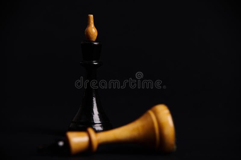 Focus on a Black King Chess Piece Fighting a White King Falling Down on ...