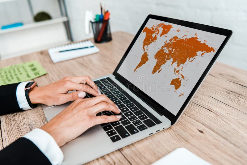 Focus of Businesswoman Typing on Laptop with Map on Screen Stock Photo ...