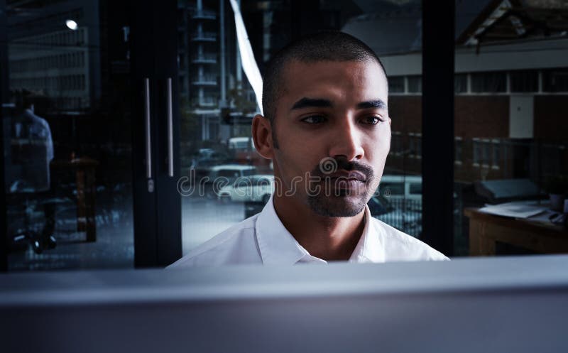 Focus and Commitment You Can Count on. a Young Businessman Using a ...