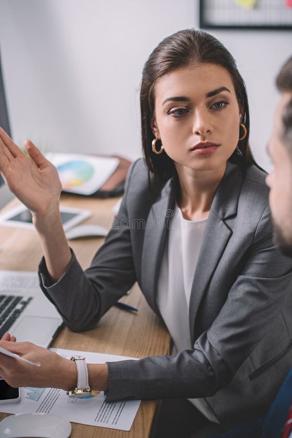 Focus of Computer Systems Analyst Looking at Colleague Near Papers with ...