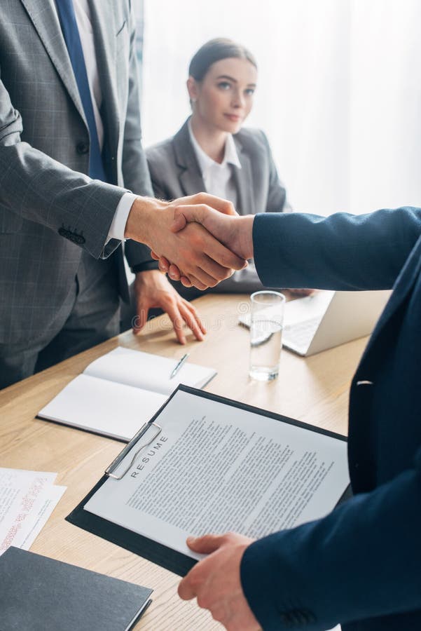 Focus of Employee with Resume Shaking Hands with Recruiter in Office ...
