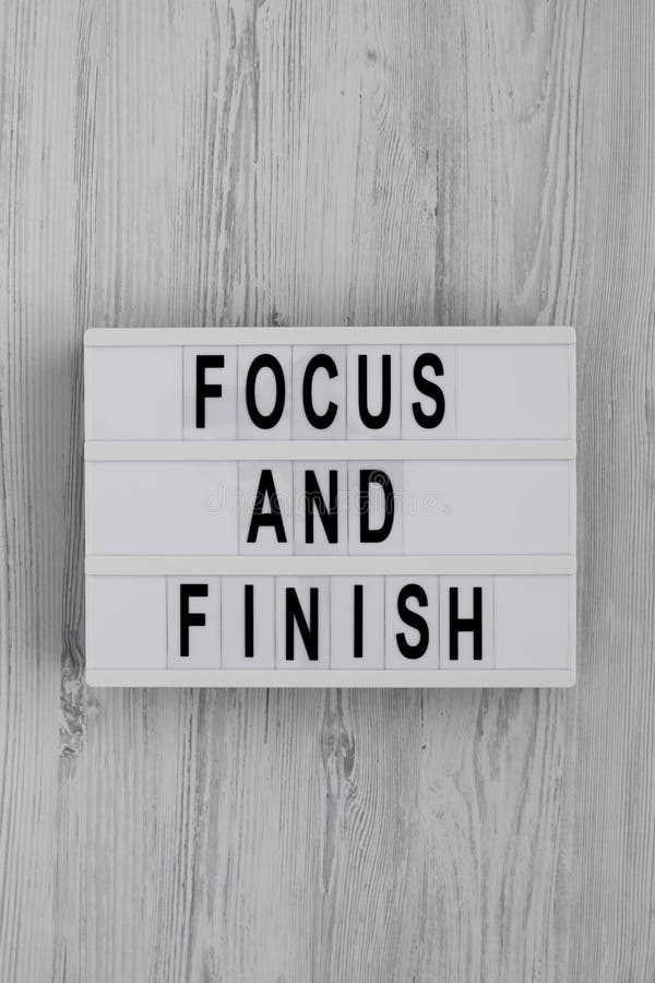 `Focus and Finish` on a Lightbox on a White Wooden Surface, Top View ...