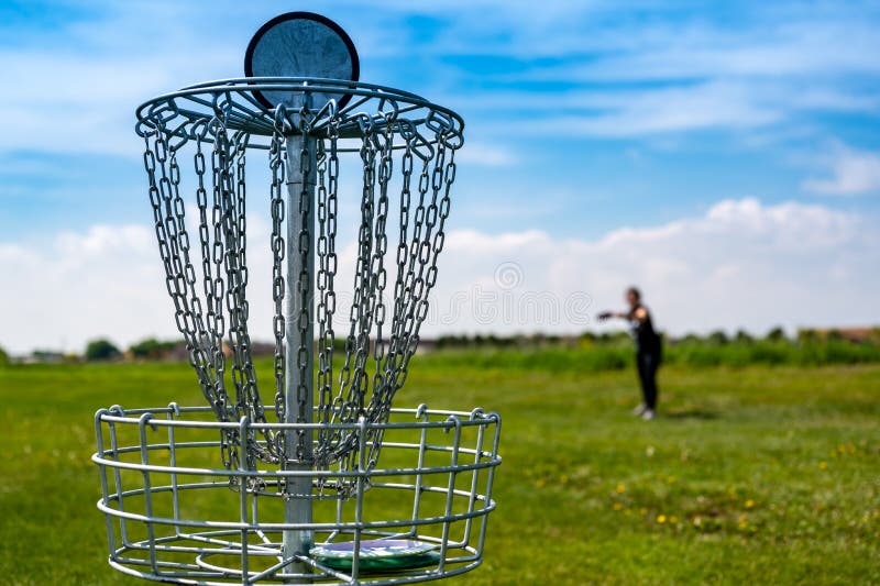 Focus on a Golf Hole while Disc is in the Air after Being Tossed by a ...