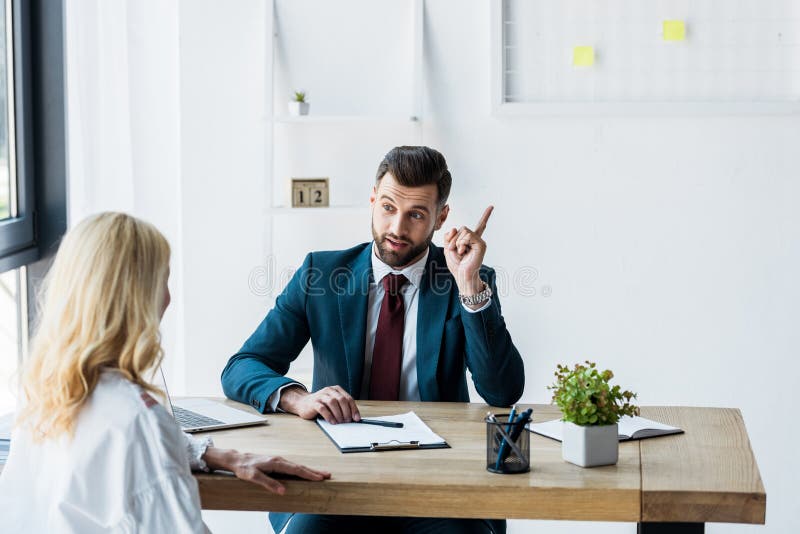 Focus of Handsome Recruiter Gesturing Near Blonde Employee in Office ...