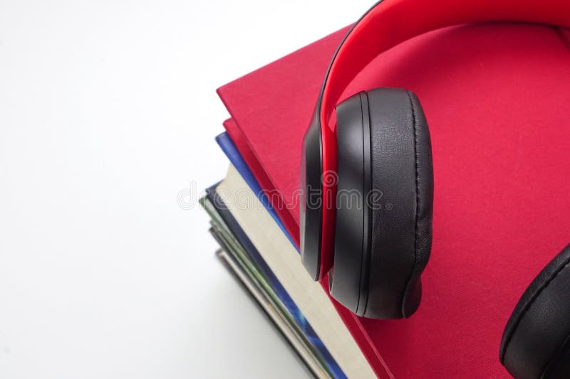 Focus of Headphones are on Stack of Books. Modern Education and ...