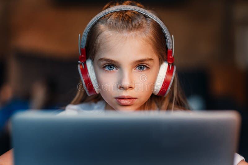 Focus of Little Girl in Headphones Using Laptop Stock Photo - Image of ...