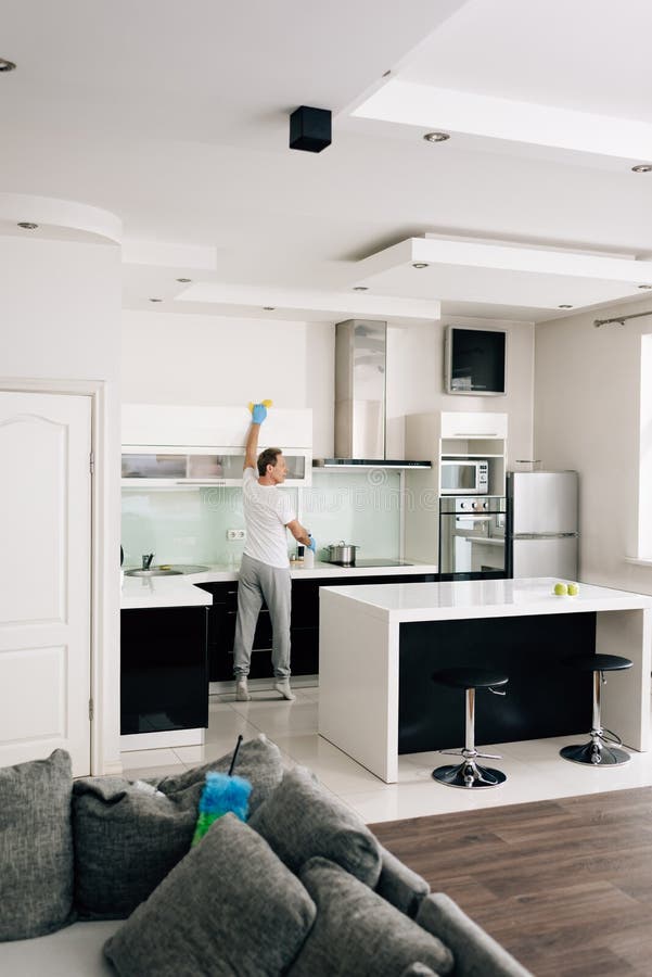 Focus of Man Cleaning Modern Kitchen at Home Stock Photo - Image of ...
