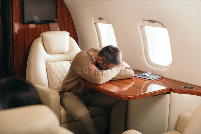 Focus of Man Covering Face while Sitting in First Class of Private Jet ...
