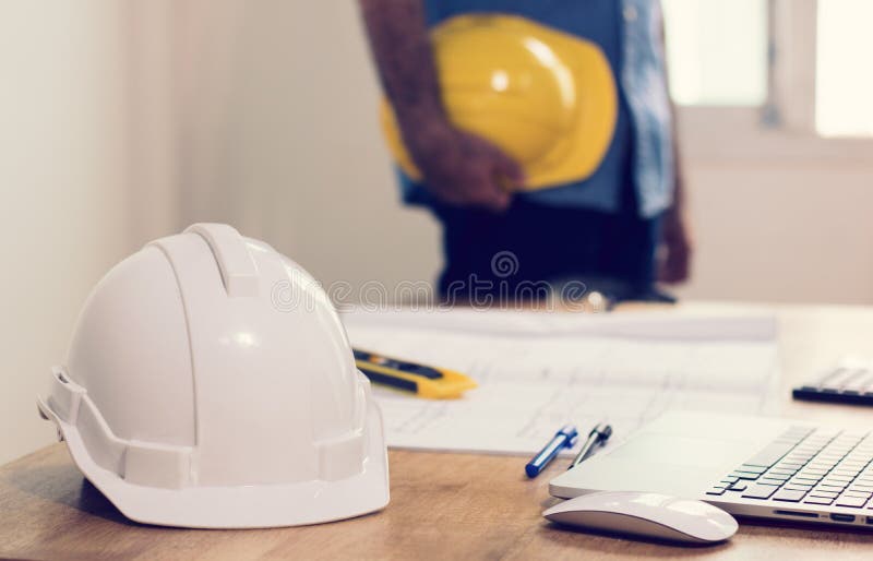 Focus at Safty Helmet on Working Desk and Two Engineer Standing Stock ...