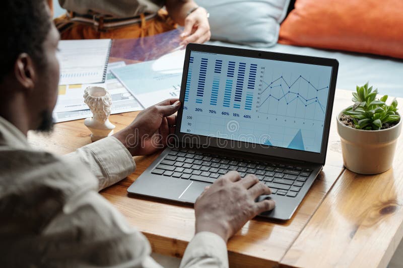 Focus on Screen of Laptop with Graphic Financial Data on Workplace ...