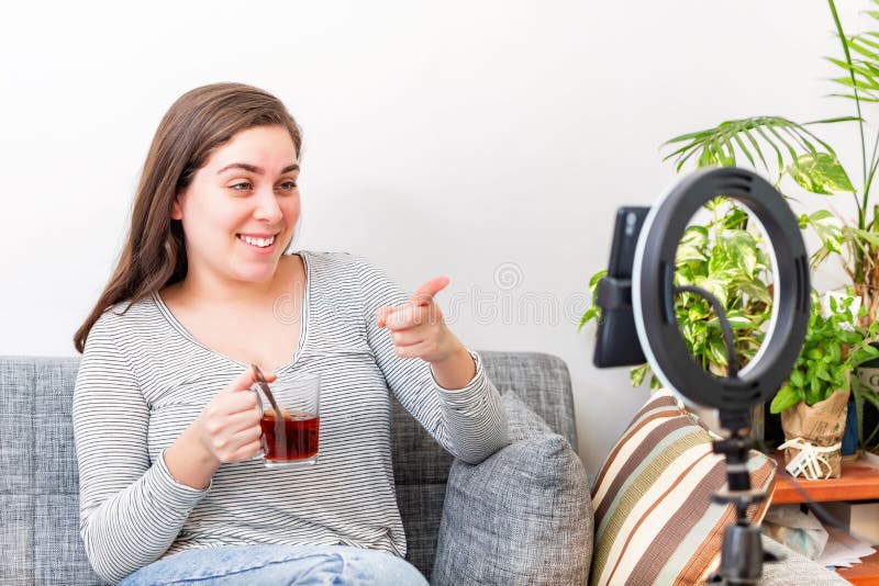 Focus Shot of a Vlogger Filming with a Smart Phone at Home. Stock Photo ...