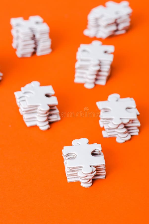 Focus of Stacks with White Puzzle Pieces on Orange Stock Photo - Image ...