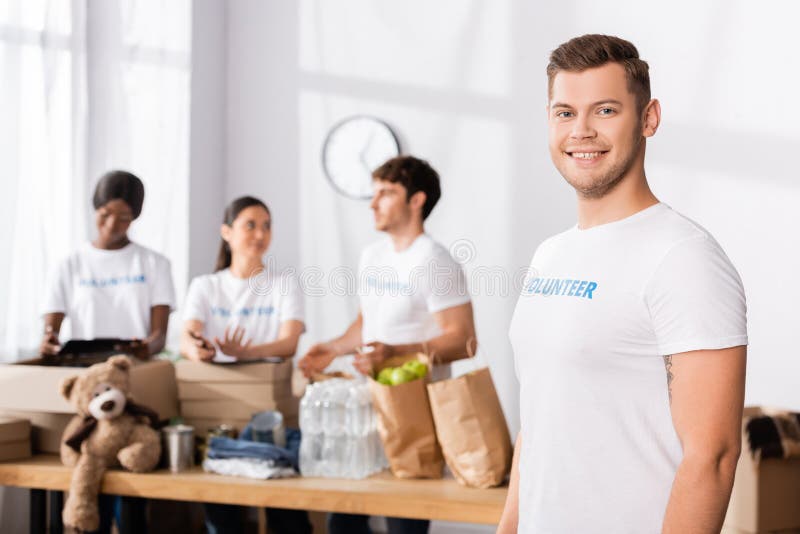 Focus of Volunteer Looking at Camera Stock Photo - Image of multiethnic ...