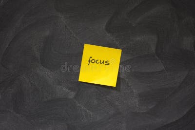 Focus on Yellow Sticky Note Against Blackboard Stock Photo - Image of ...