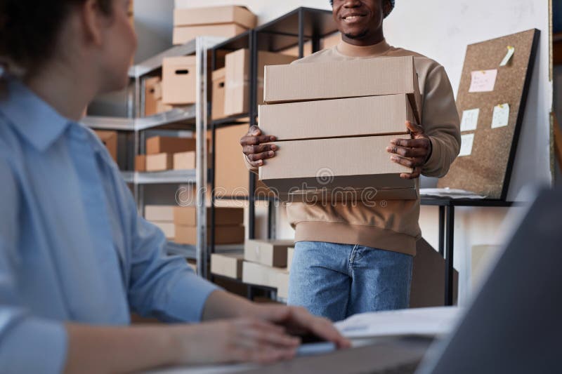 Focus on Young Black Man Carrying Stack of Packed Boxes To His ...