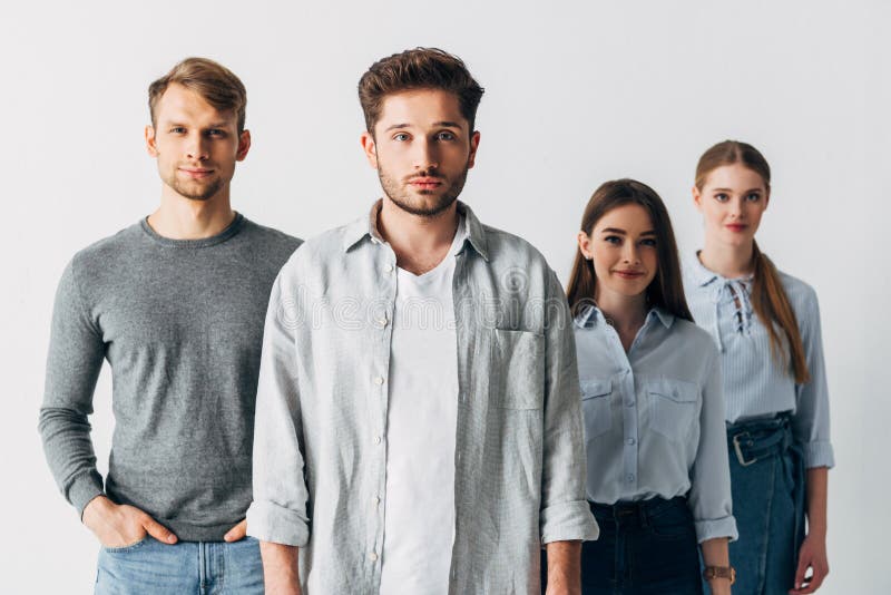 Focus of Young Man Looking at Camera Near Coworkers in Office Stock ...