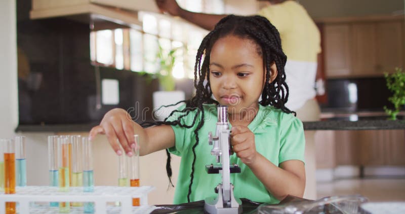 Focused African American Daughter Using Microscope, Doing Science ...