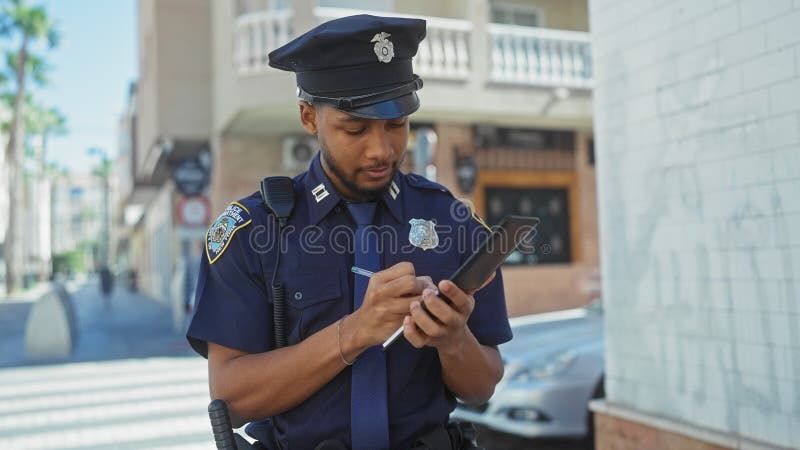 Focused African American Policeman Using Tablet on City Street Stock ...