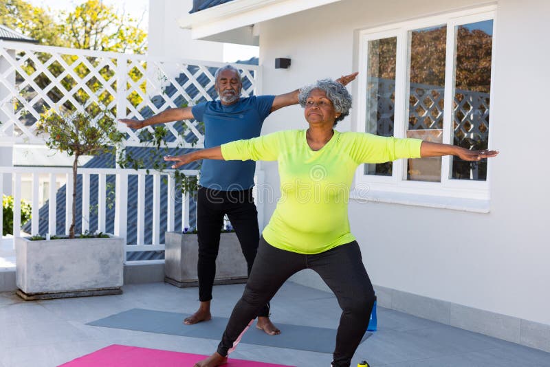 Focused African American Senior Couple Practicing Yoga in Garden Stock ... Focused African American Senior Couple Practicing Yoga in Garden Stock ...