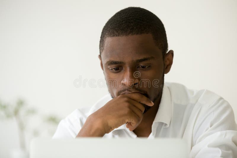 Focused African Manager Working on Laptop Thinking of Problem so Stock ...