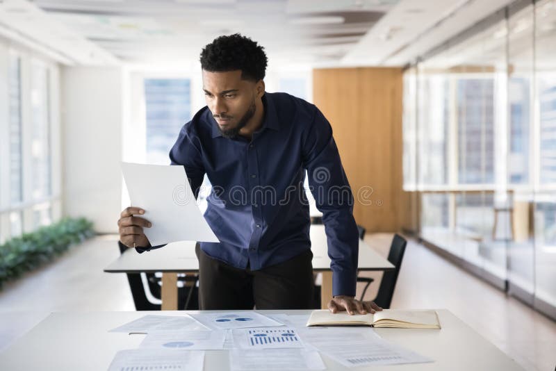 Focused African Professional Engaged in Data Analysis and Decision ...