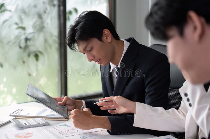 Focused Analysis and Planning. Professionals Reviewing Data and Notes ...