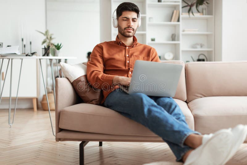 Focused Arab Man in Headphones Using Pc at Home Stock Image - Image of ...