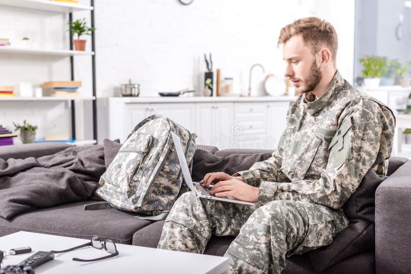 Focused Army Soldier Using Laptop on Couch Stock Image - Image of ...