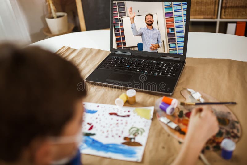 Boy Painting and Watching Online Course on Laptop while Practicing at ...