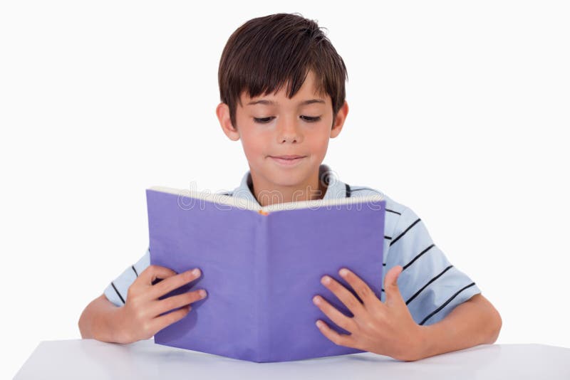 Focused boy reading a book stock image. Image of caucasian - 22692075