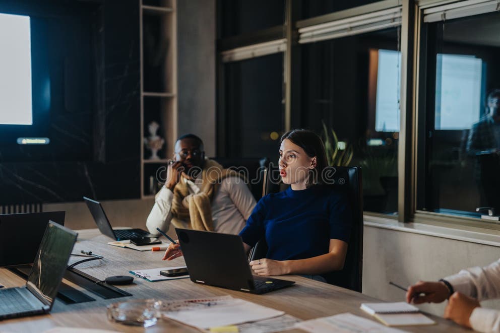 Focused Business Team Working Late at Night in Modern Office Setting ...