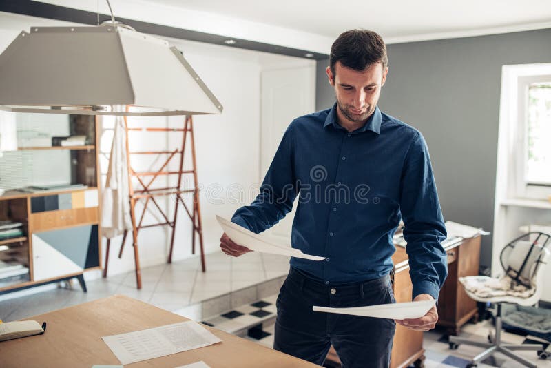 Focused Businessman Reading Documents in a Large Work Studio Stock ...