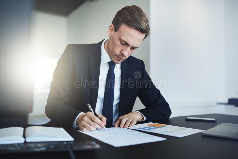 Businessman Signing Documents while Sitting at His Office Desk Stock ...