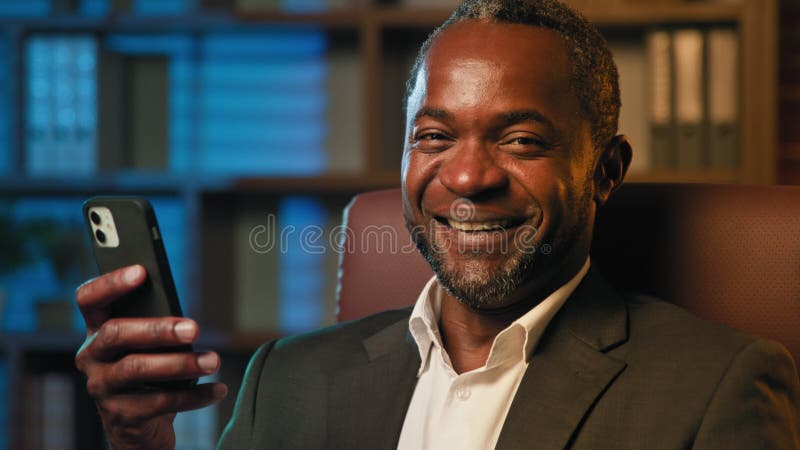 Focused Businessman Sitting in Office Holding Smartphone Browsing Email ...
